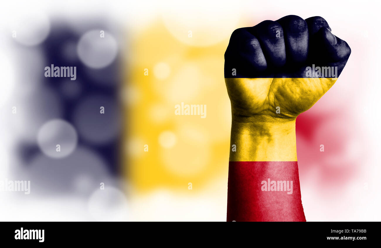 Flag of Chad painted on male fist, strength,power,concept of conflict ...