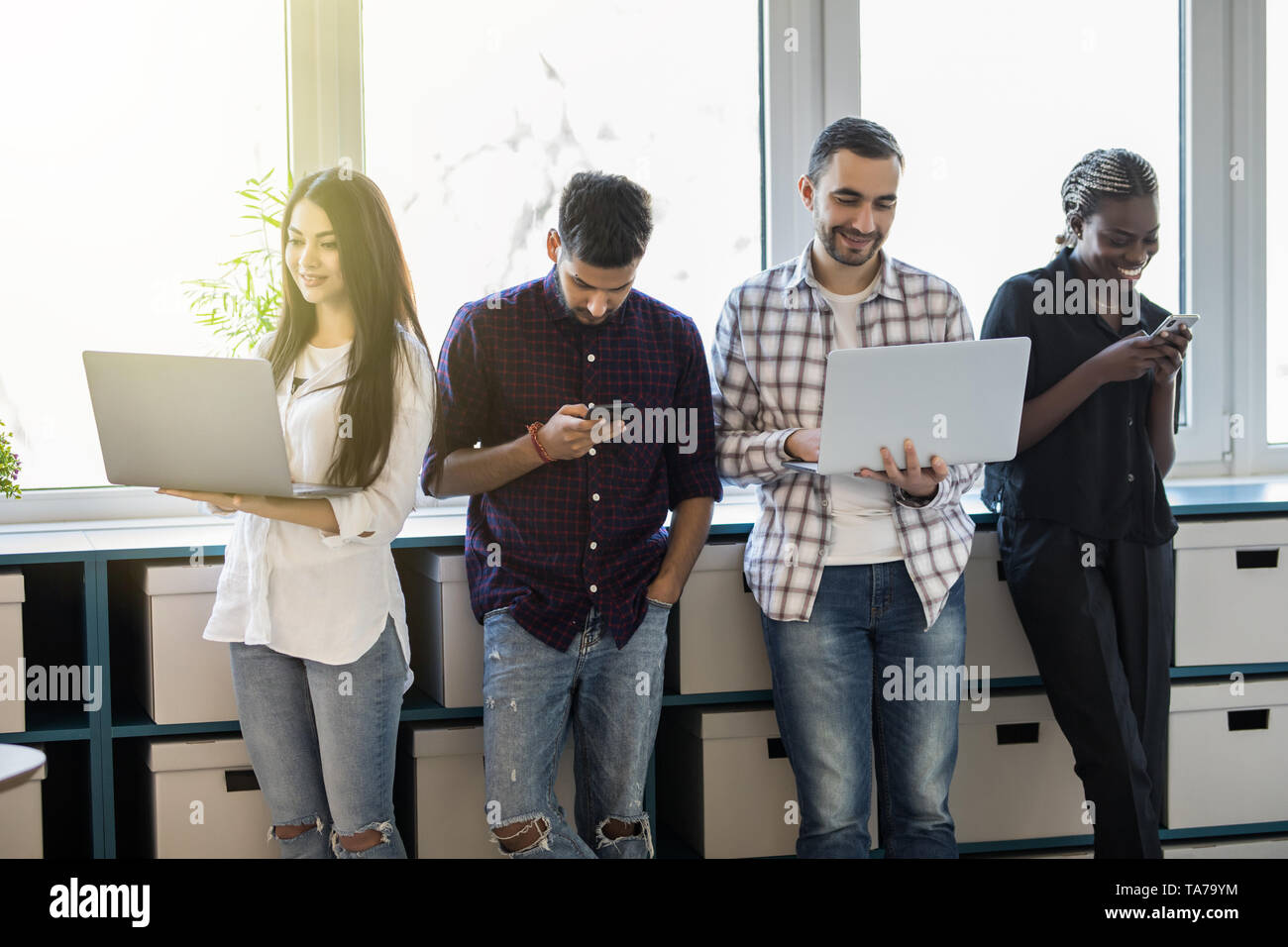 Mixed race Business people using digital devices Stock Photo - Alamy