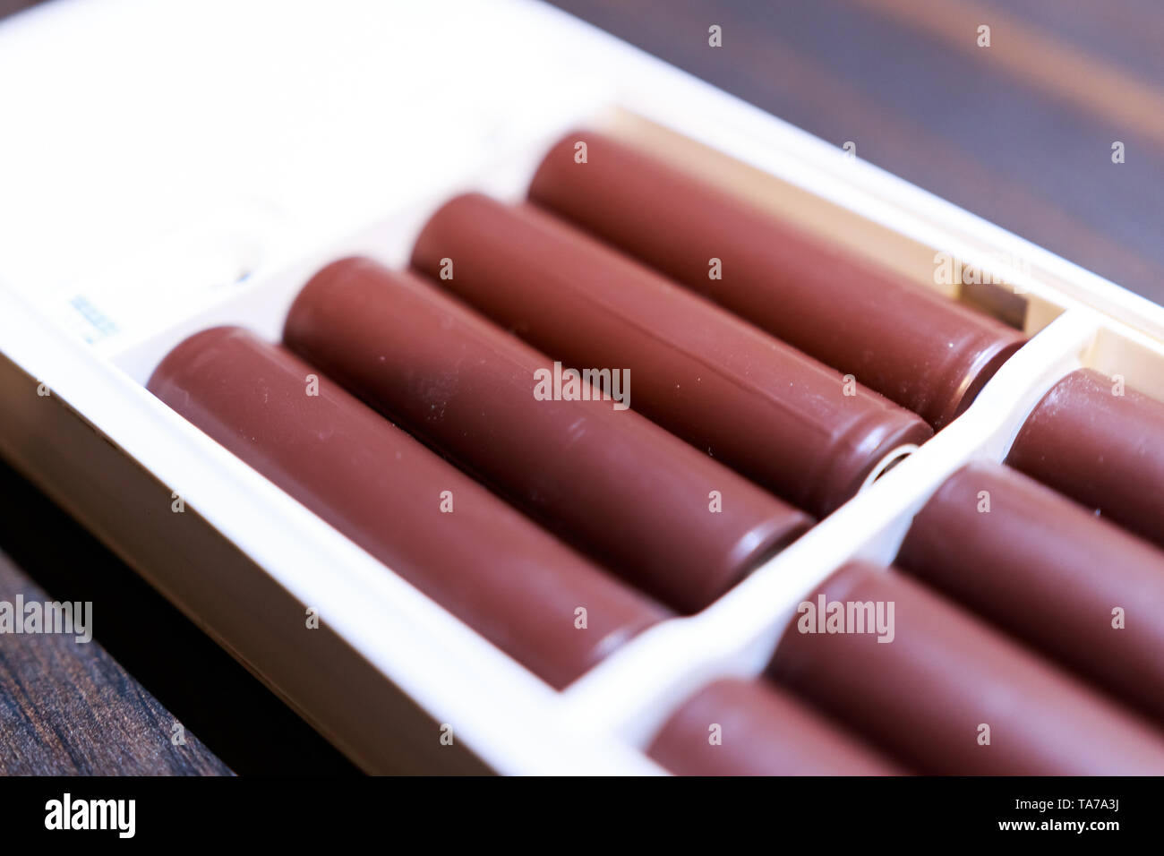 Brown 18650 Lithium Ion Battery Cell being charged in a batch charger ...