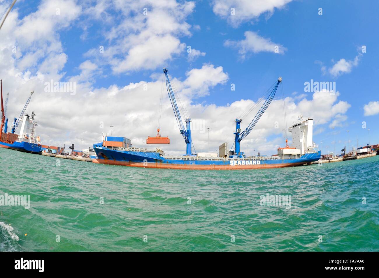 Large ocean container ship with containers being lifted onto ship with ...
