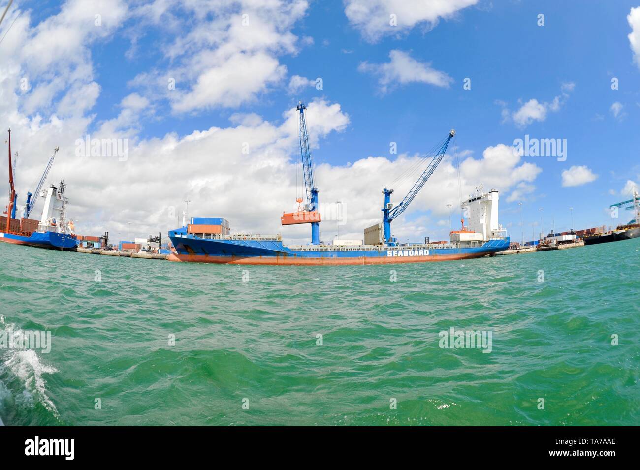 Large ocean container ship with containers being lifted onto ship with ...