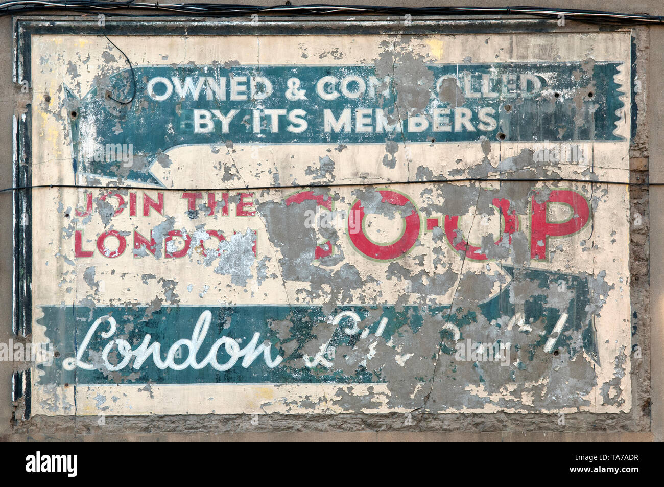 An Old Worn Advertisement For The London Co Op Painted On The Side Of A ...