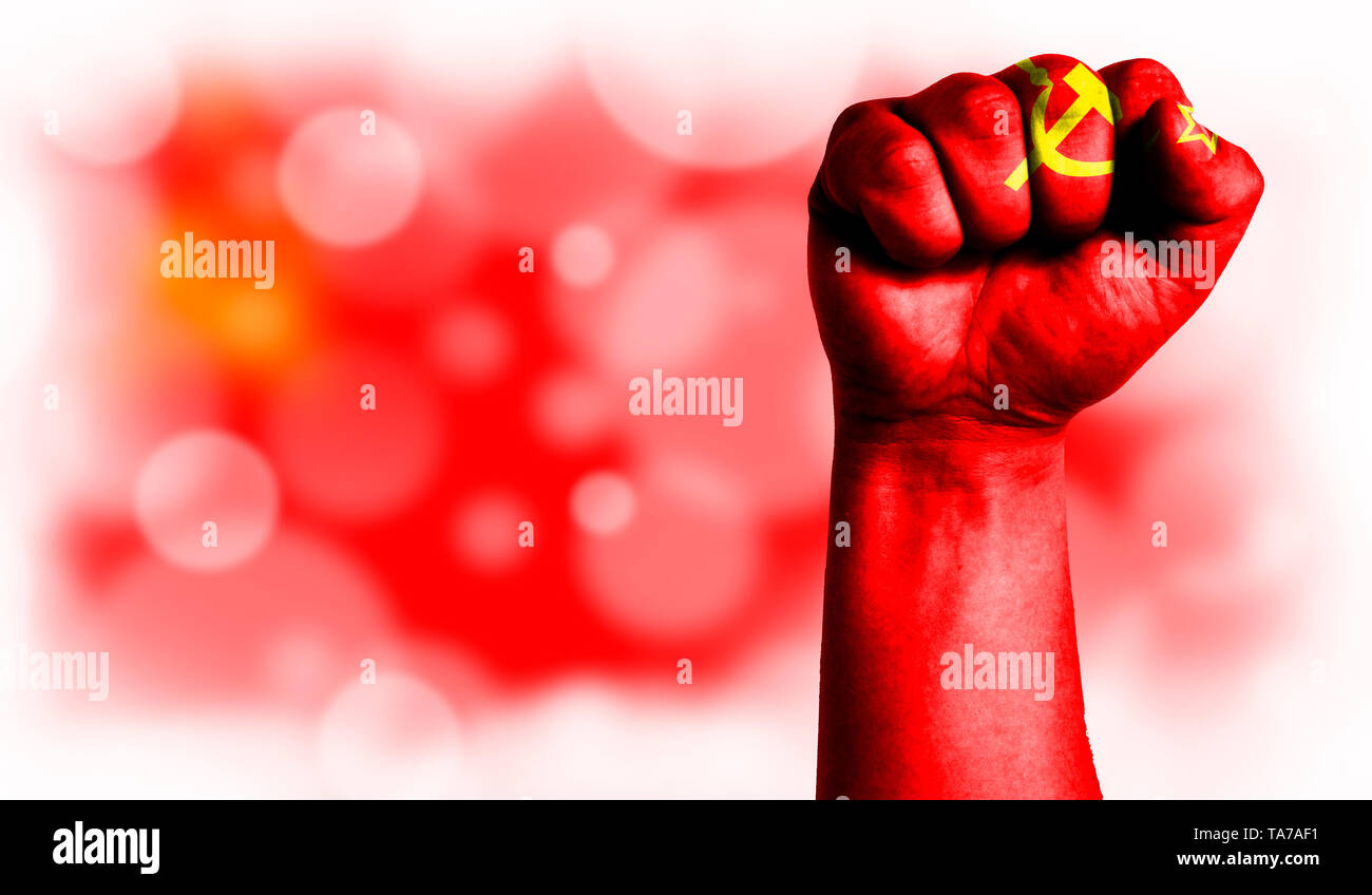 Flag of USSR painted on male fist, strength,power,concept of conflict ...