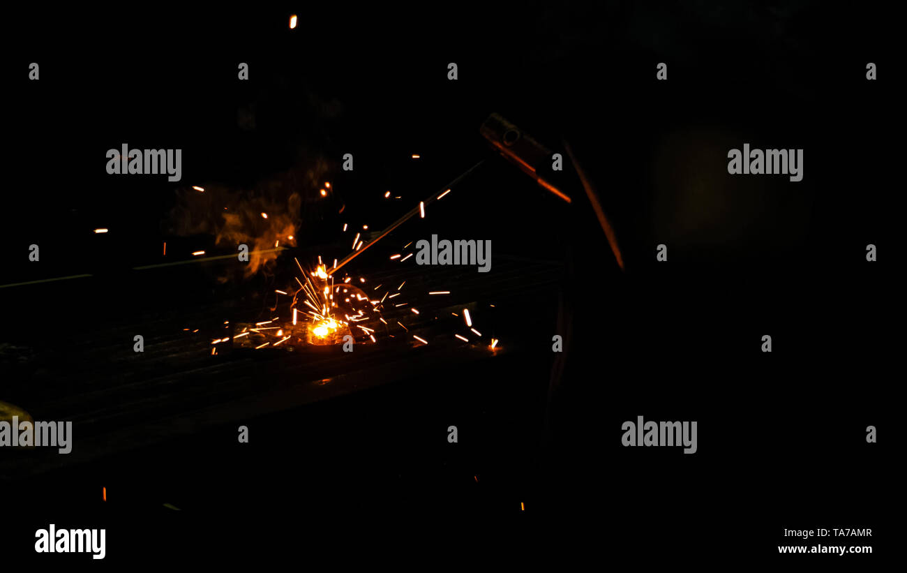 Smoke and spark with colorful glowing particles from electric metal ...