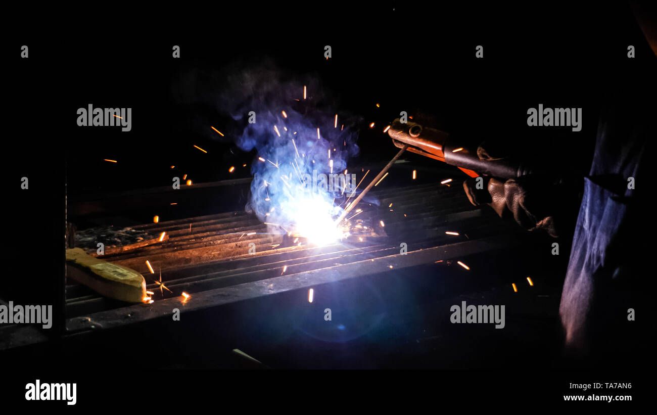 Smoke and spark with colorful glowing particles from electric metal ...