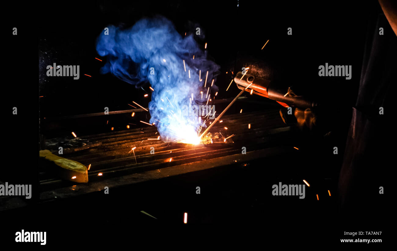 Smoke and spark with colorful glowing particles from electric metal ...
