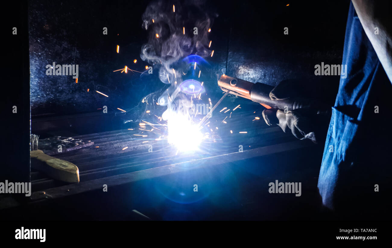 Smoke and spark with colorful glowing particles from electric metal ...