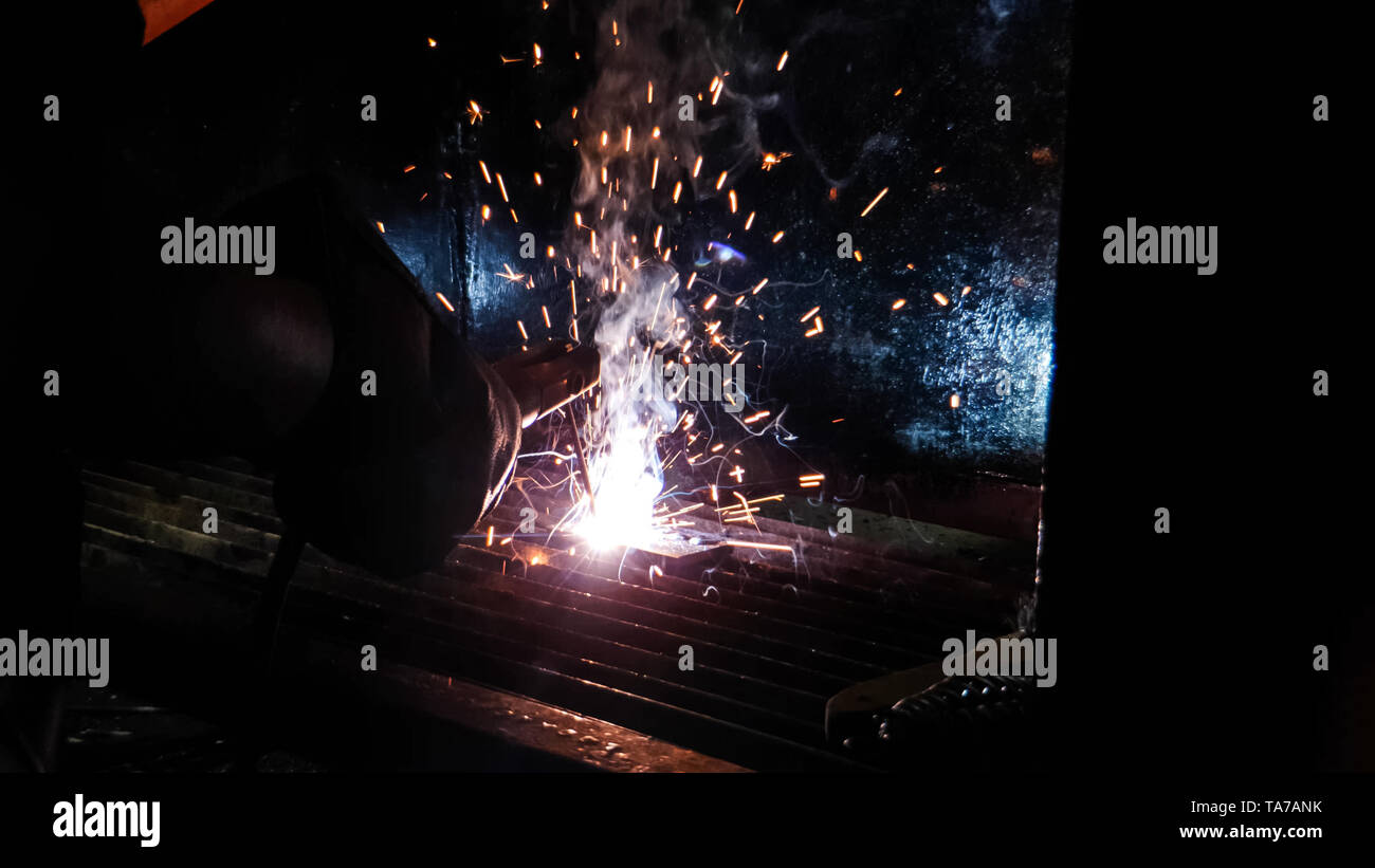 Smoke and spark with colorful glowing particles from electric metal ...