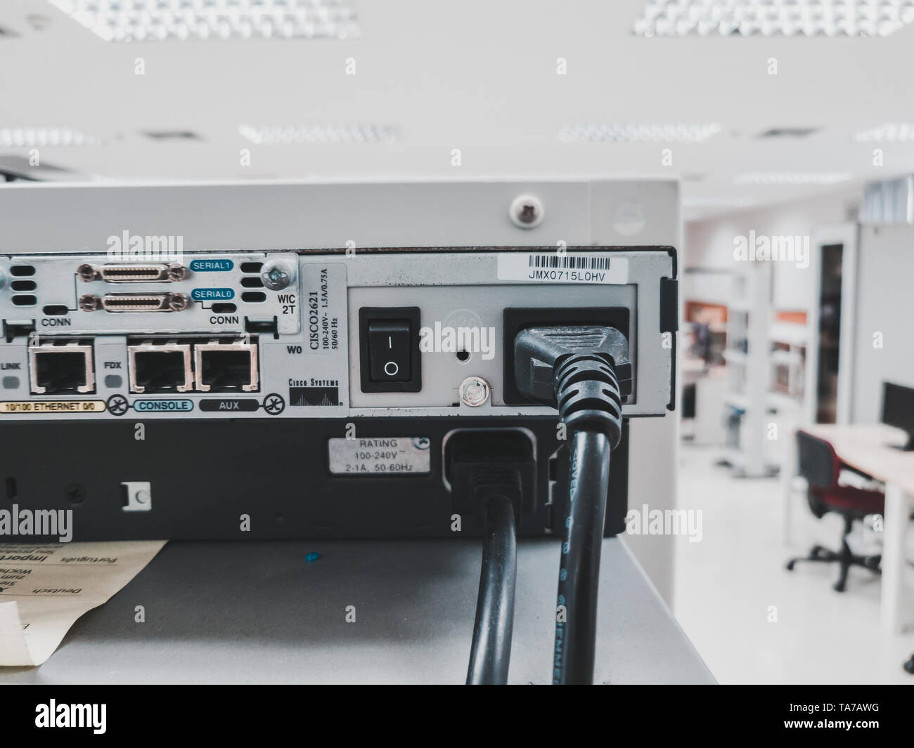 Close up of AC power cable plugged into the back of rack server with ...