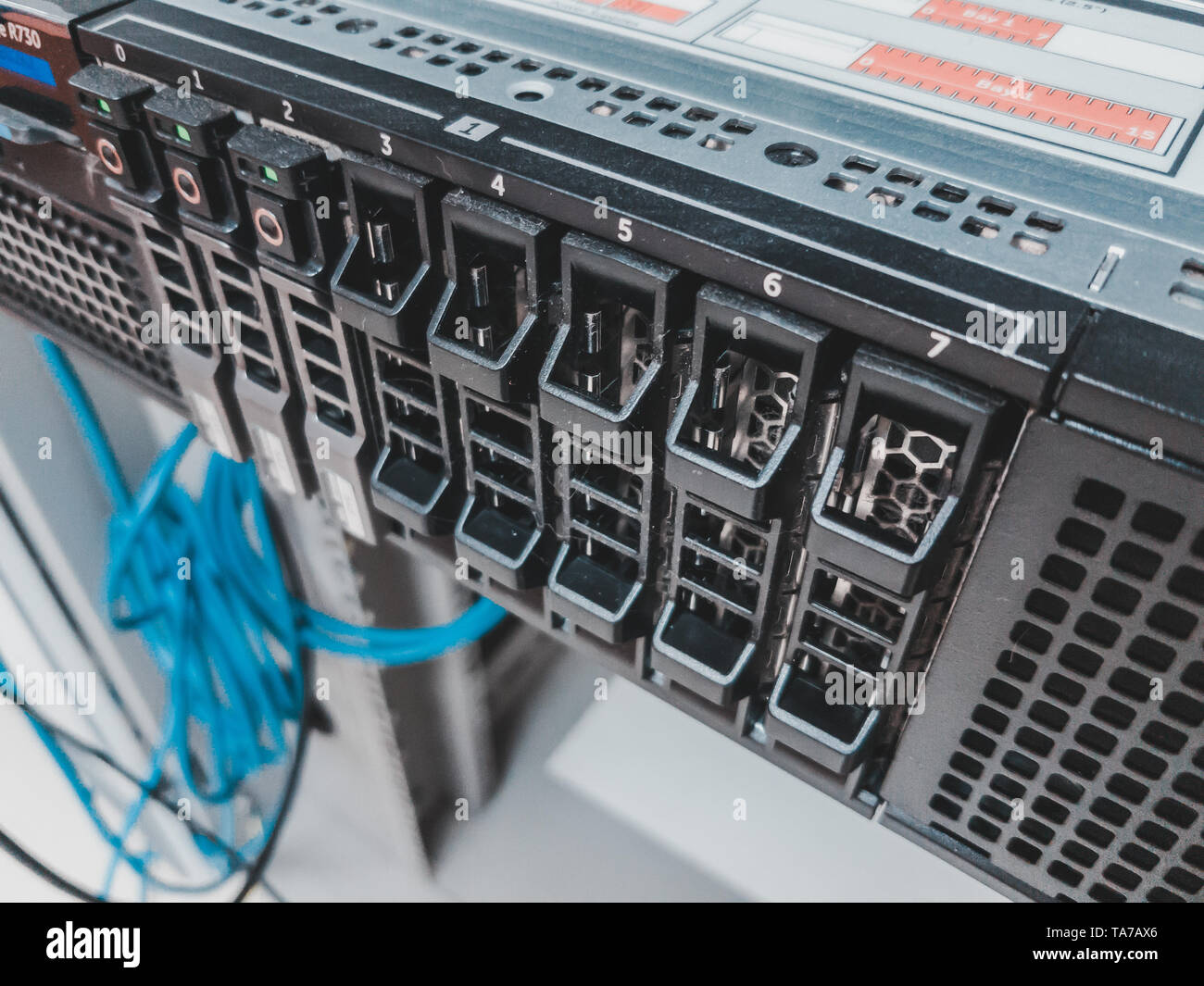 Close up of 2.5 inches hard drives bay in front of a working rack ...