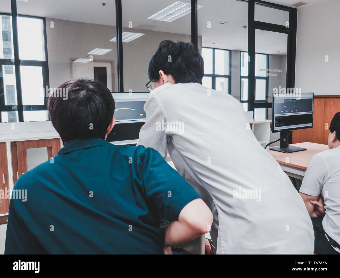 Thai Computer Engineering students working on a programming project in ...