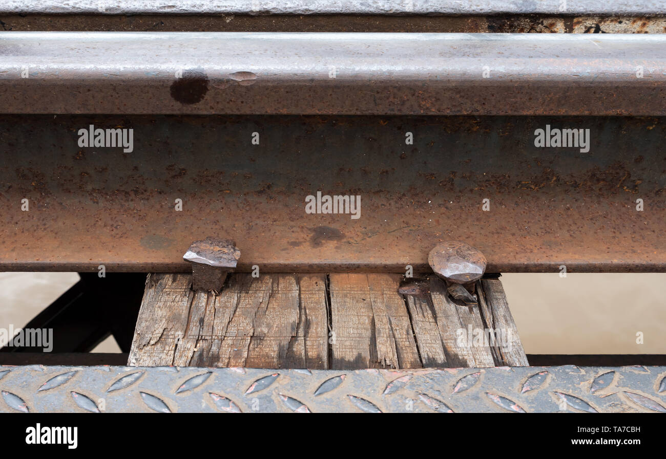 Closeup of the railway and metal peg on the wooden sleeper of the old ...