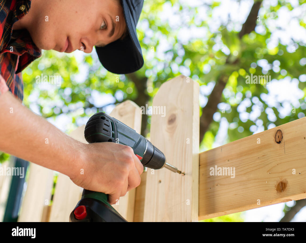 Young man using drill machine hi-res stock photography and images - Alamy