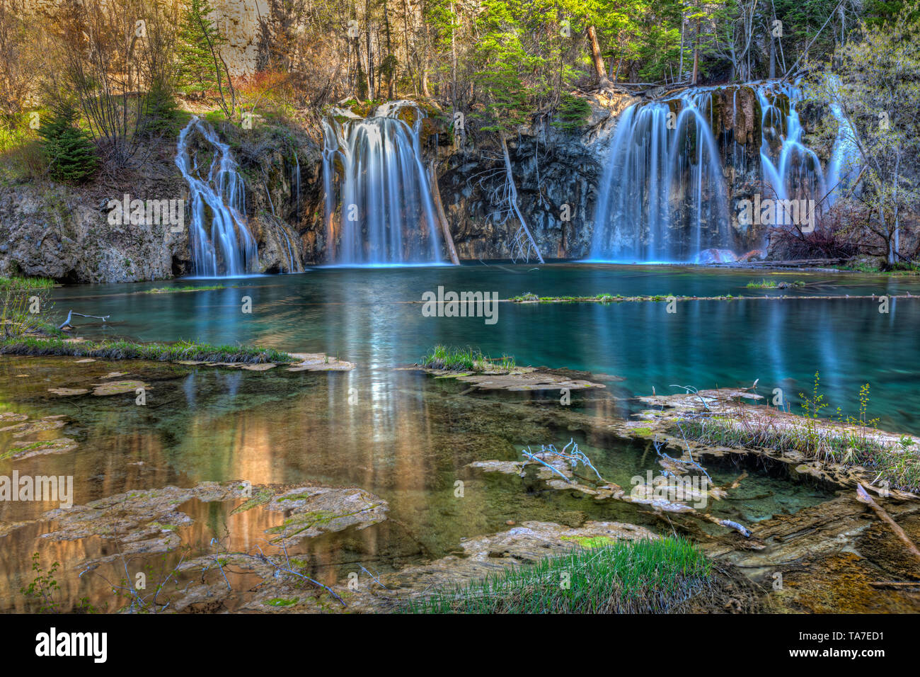 Warm morning sun reflects off the cliffs above the Hanging Lake ...