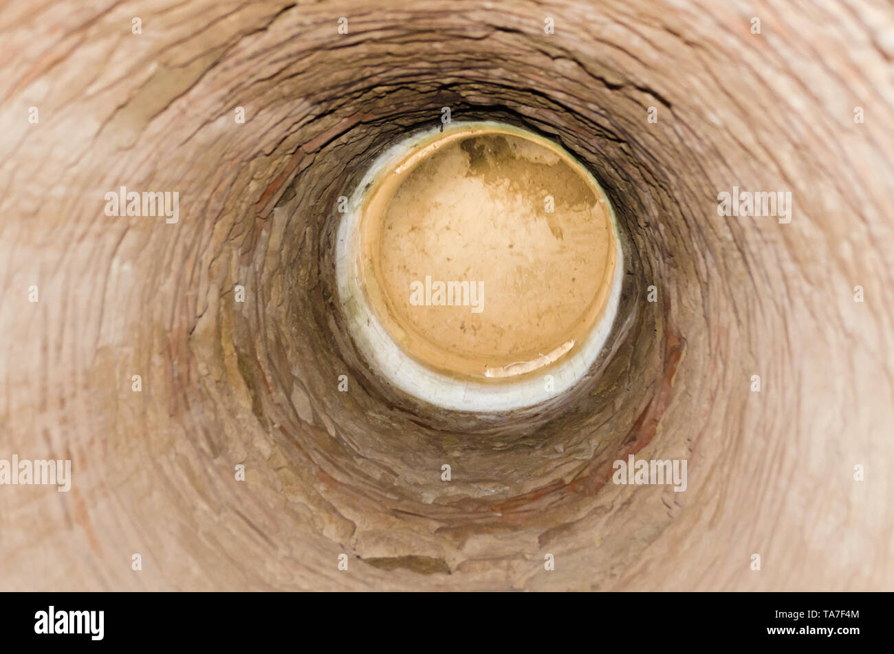 Hole deep in the ceiling. Inside cave with through hole on cave ceiling ...