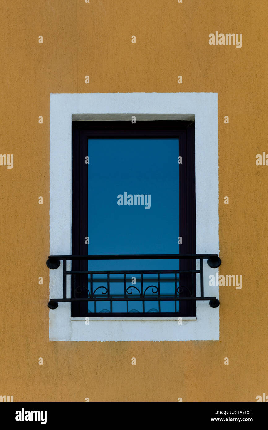 Window on the yellow building facade in Bulgaria, closed window in the ...