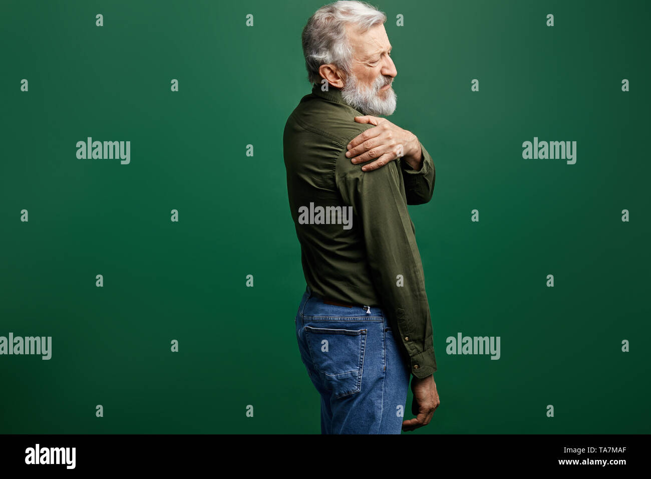 old man massaging his shoulder to reduce pain. close up side view photo ...