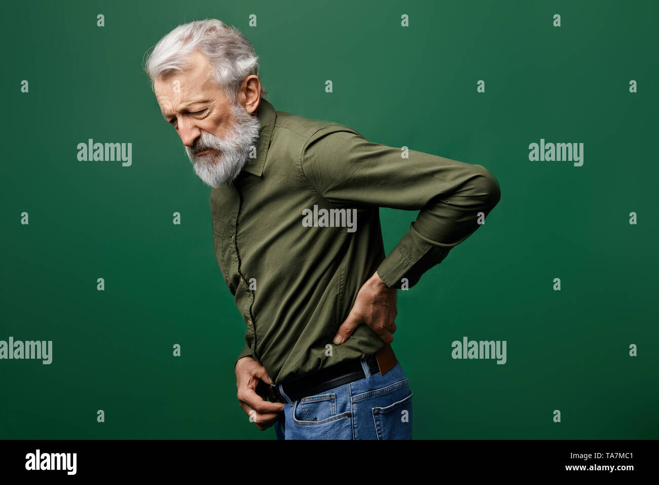 old man suffering from referred pain in the back. weakness concept ...