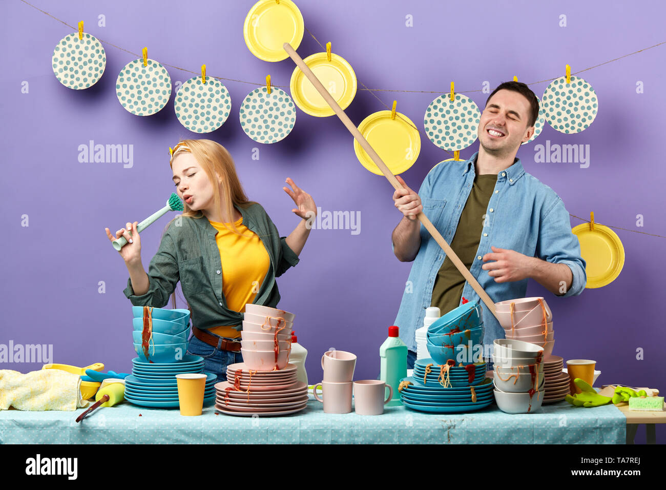 awesome couple singing while doing household chores.housework and ...