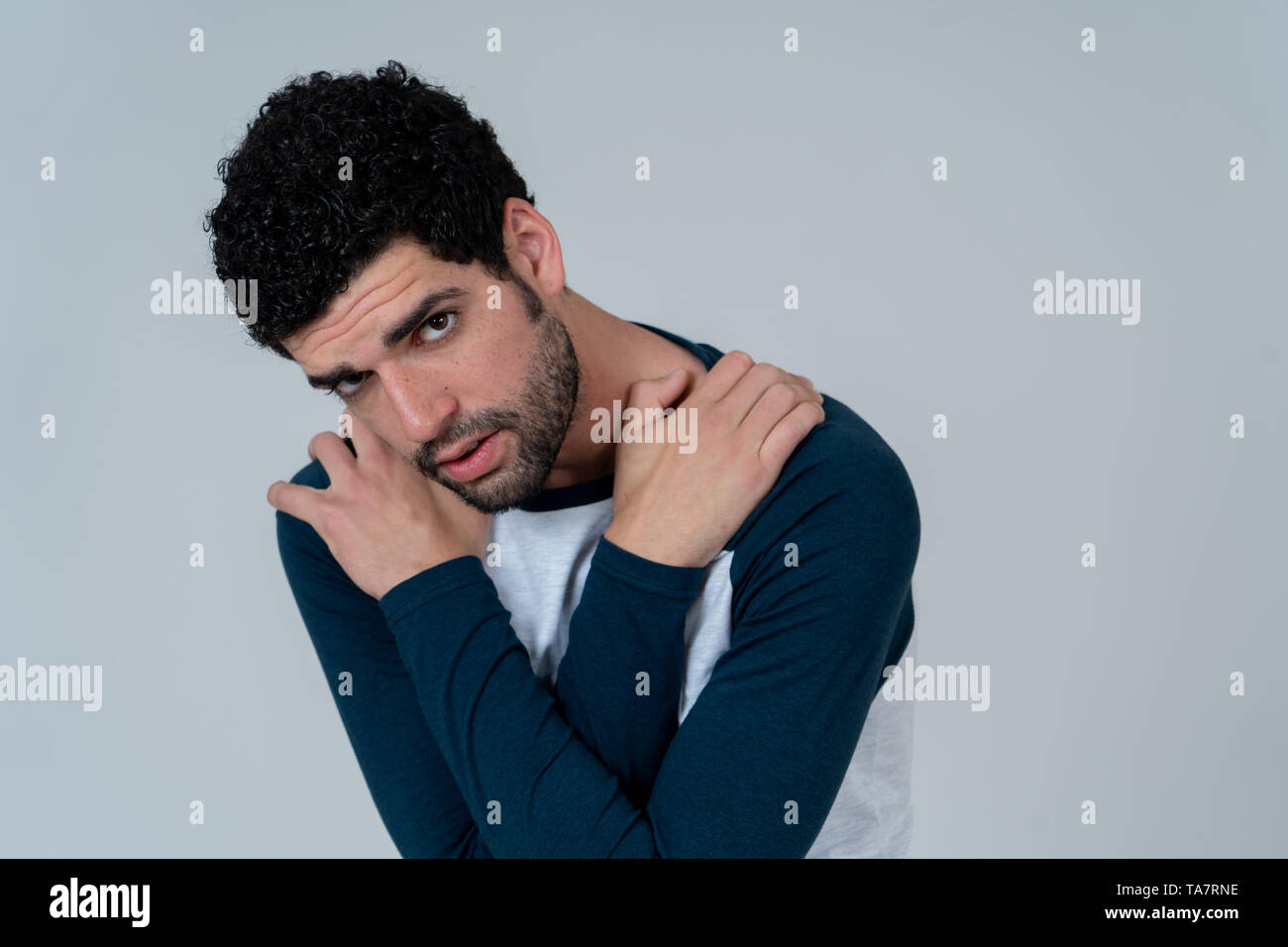 Young sad man, worried and concerned, looking depressed and desperate ...