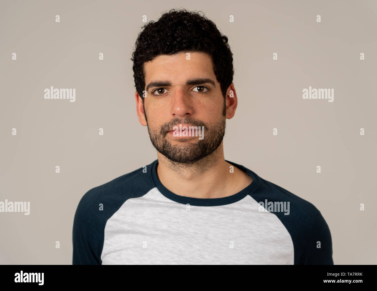 Close up headshot of young latin man with natural and neutral face ...