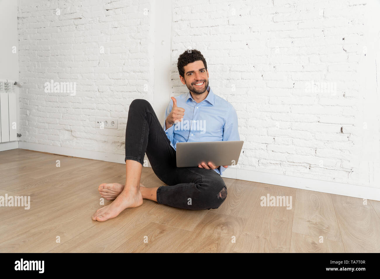 Real state agent or house hunter man on laptop at new studio. Young ...