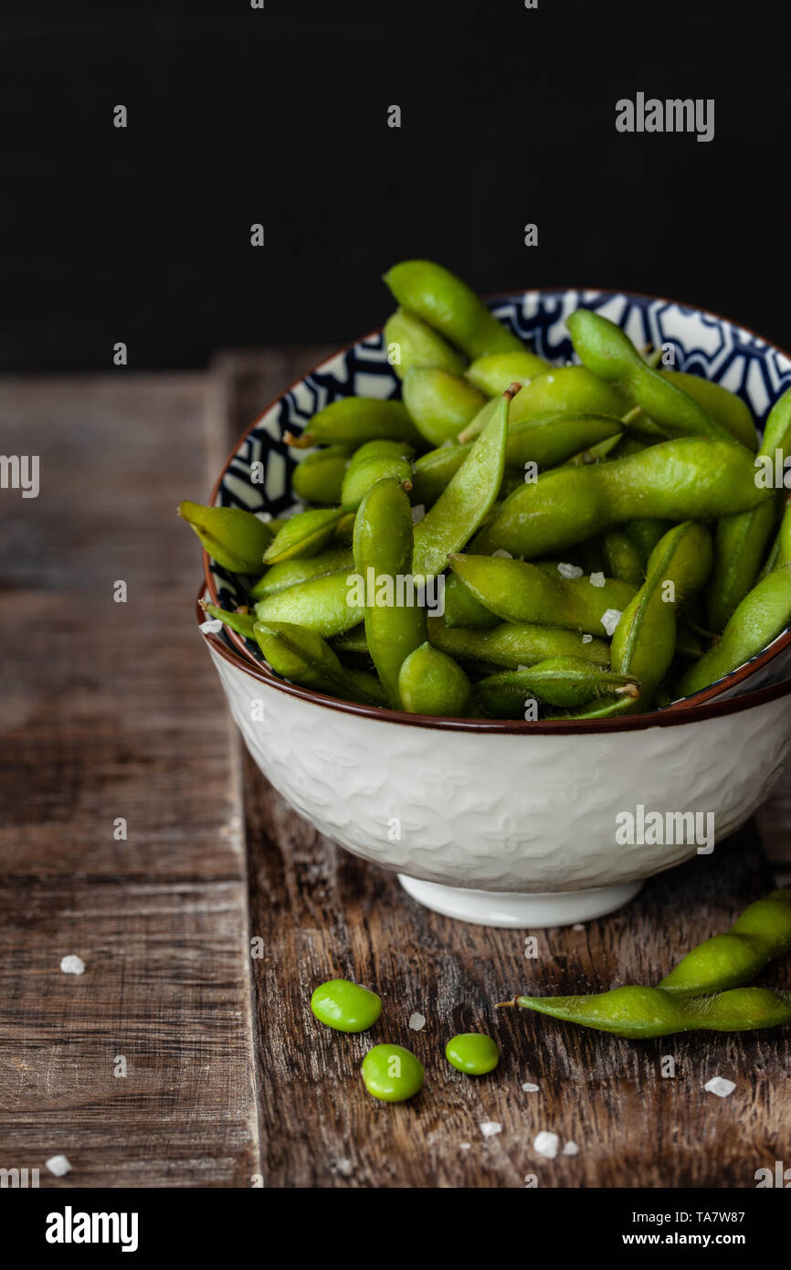 Bowls of fresh green soy beans with salt Stock Photo - Alamy
