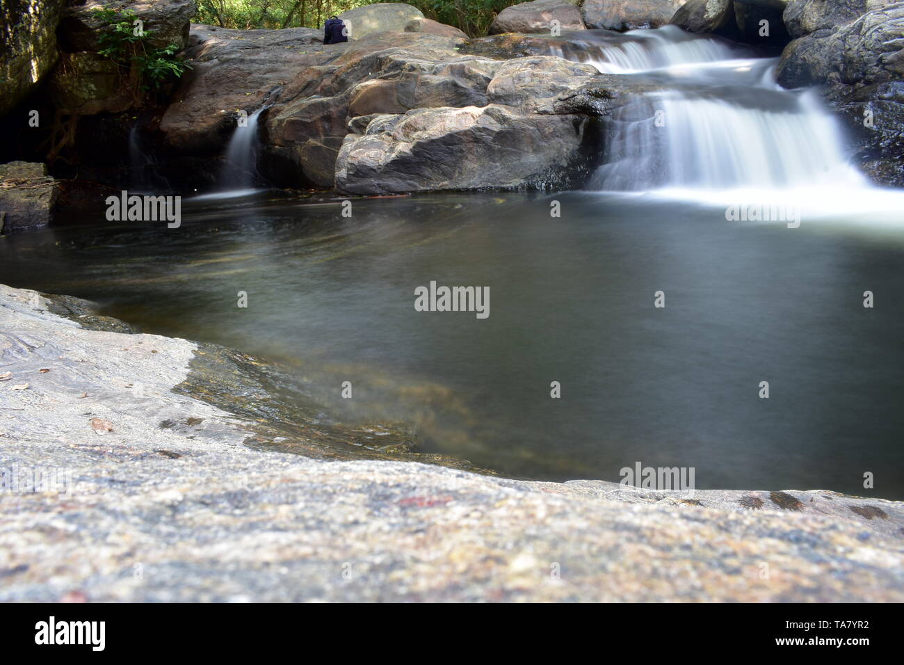 Kumbakkarai Water Falls and the Pambar river flows along the rocks ...