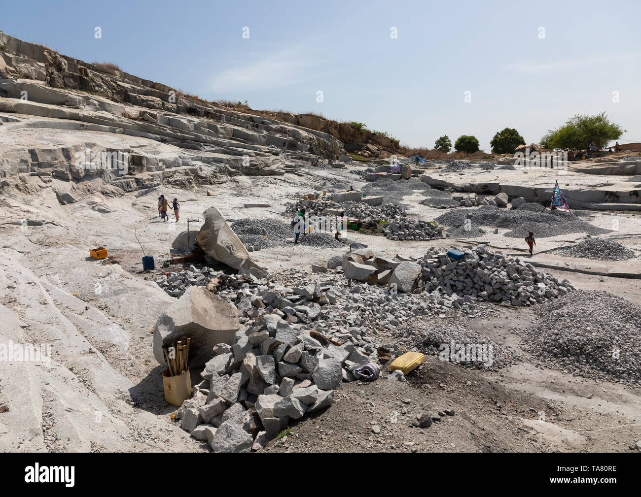 African people working in a granite quarry, Savanes district, Shienlow ...