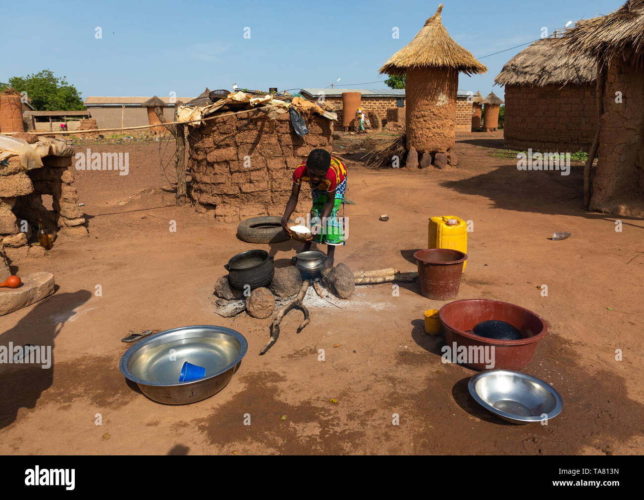 African woman preparing food in the house courtyard, Savanes district ...