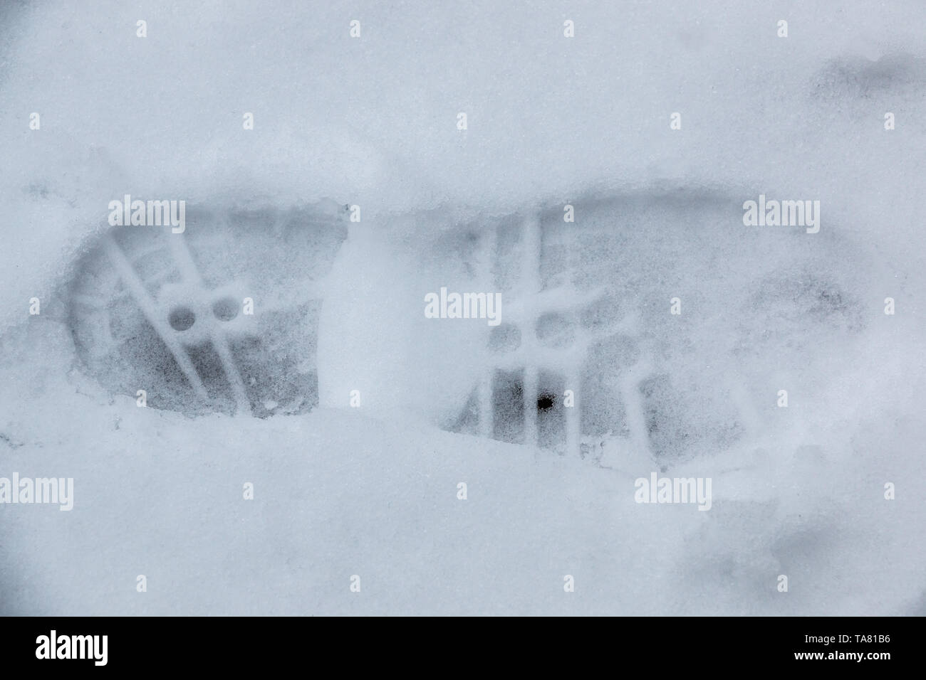 Foot print of a human shoe on the white snow Stock Photo - Alamy