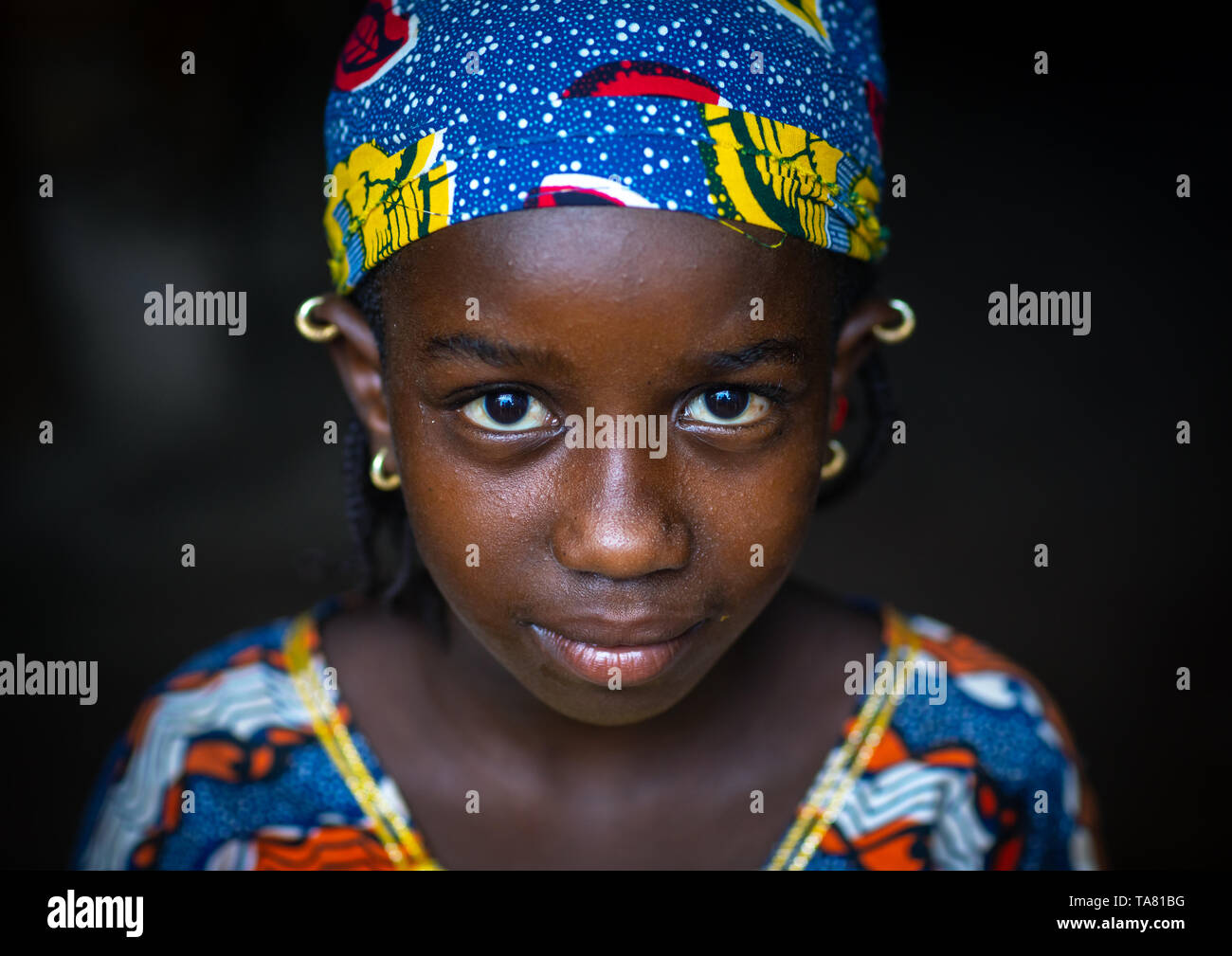 Portrait of a Peul tribe girl with colorful clothes, Savanes district ...