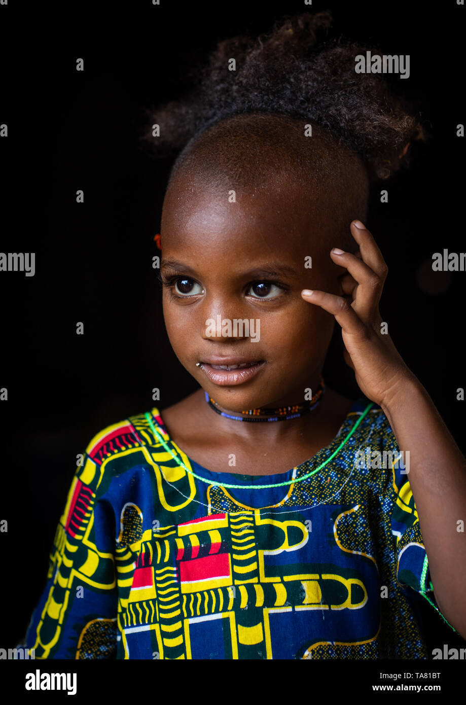 Portrait of a Peul tribe girl with a strange haircut, Savanes district ...