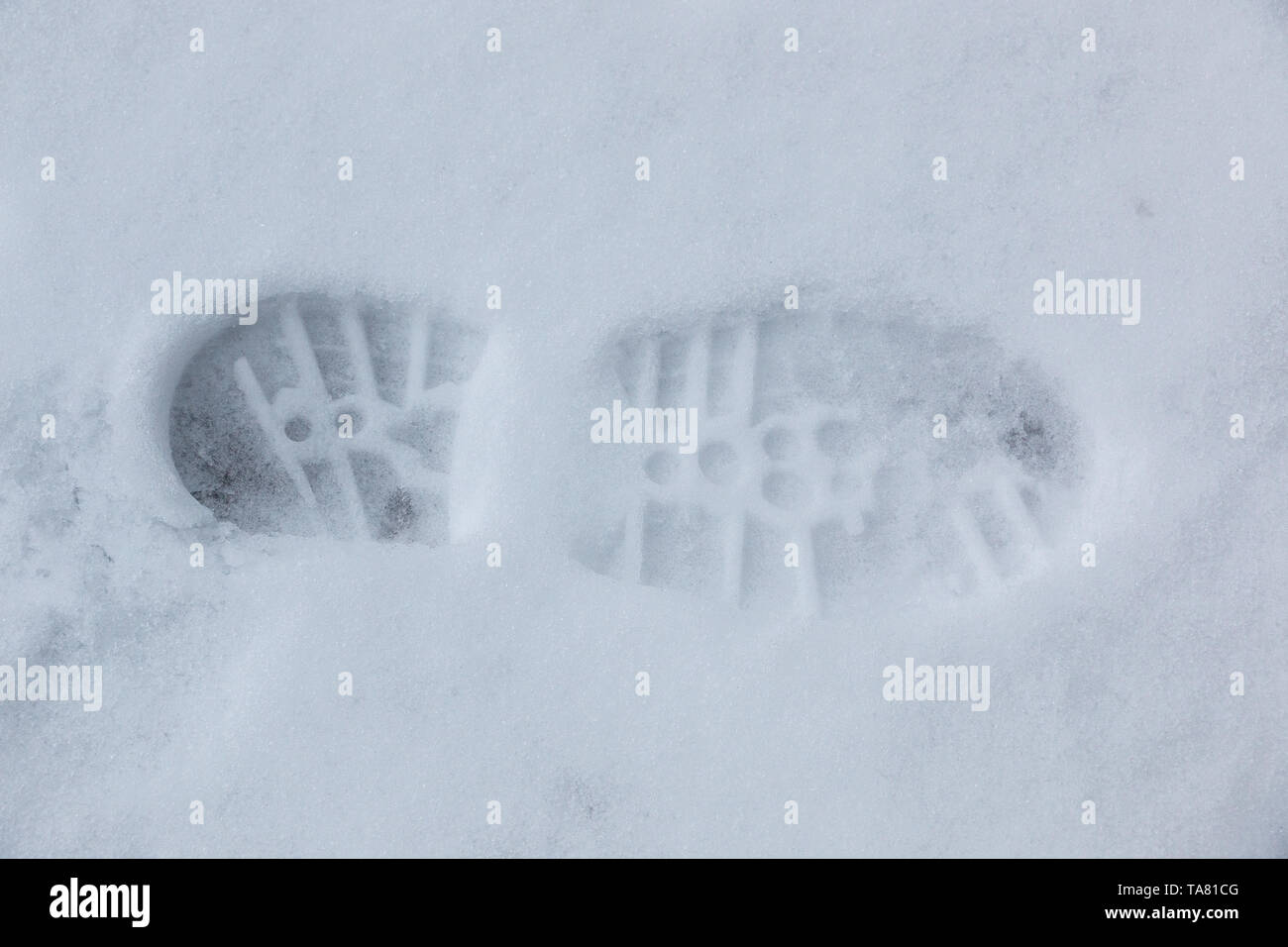 Foot print of a human shoe on the white snow Stock Photo - Alamy