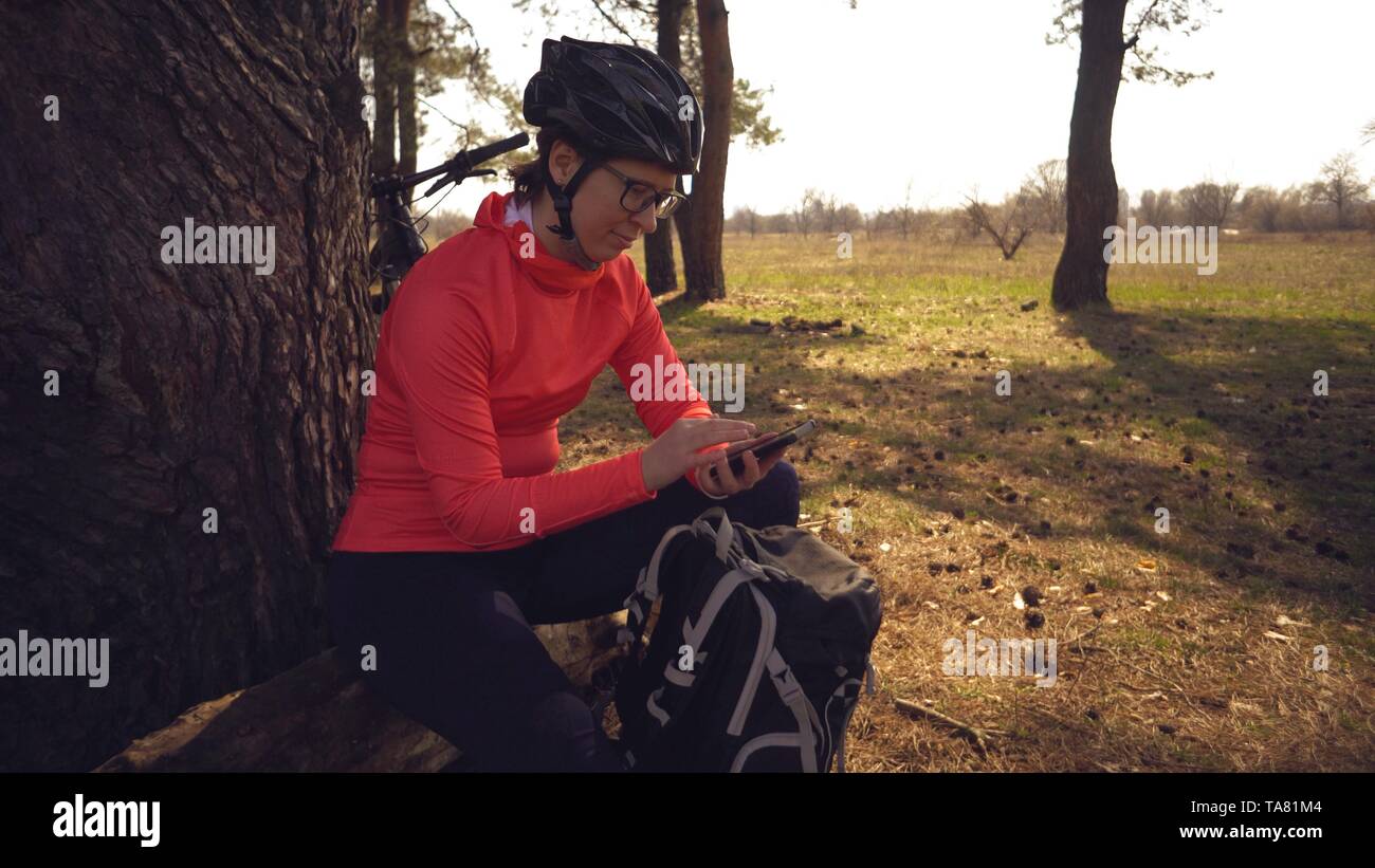 Caucasian sport cyclist woman sport off road bike park near tree. woman ...