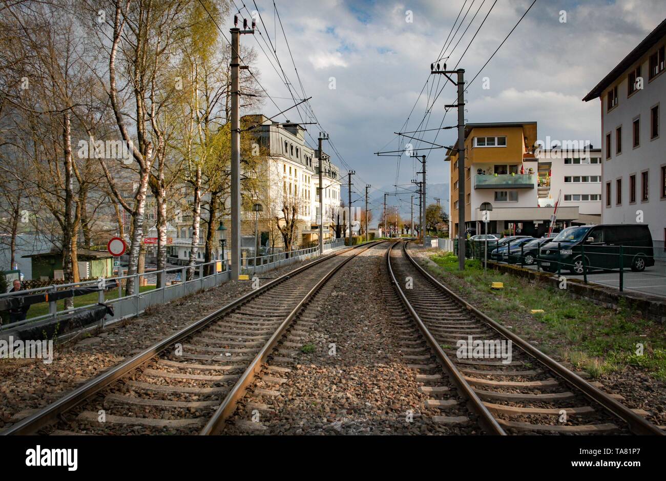 train rails in austrian alpine ski village in the alps in the spring ...