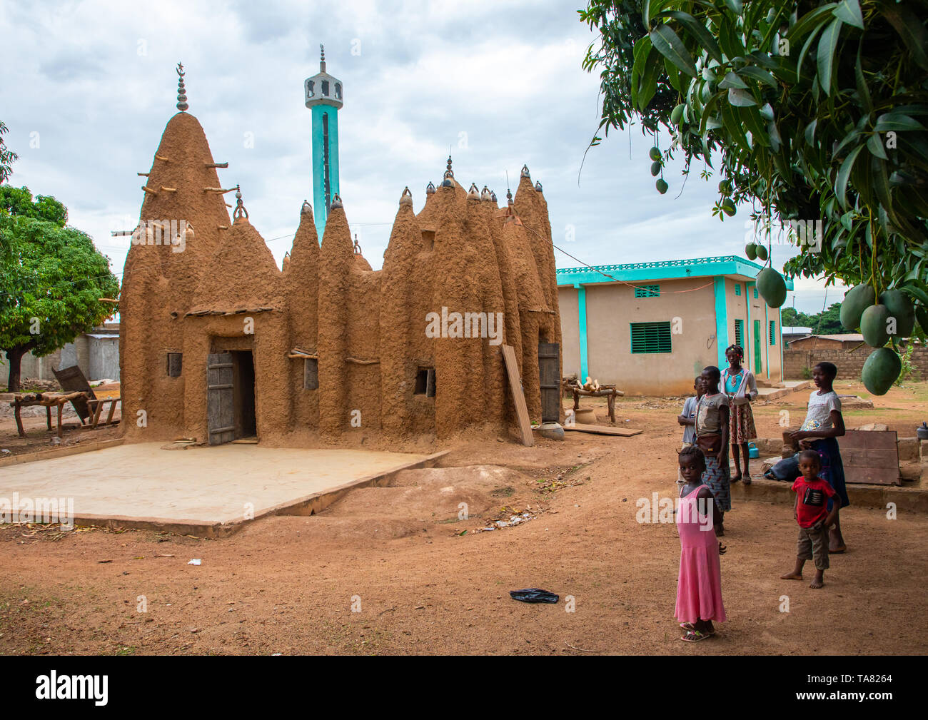 African children in front of a sudano-sahelian style mud mosque ...