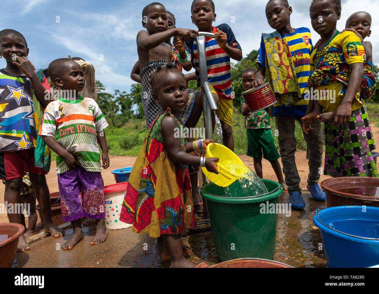 African children collecting water from a well with a pump, Bafing, Yo ...