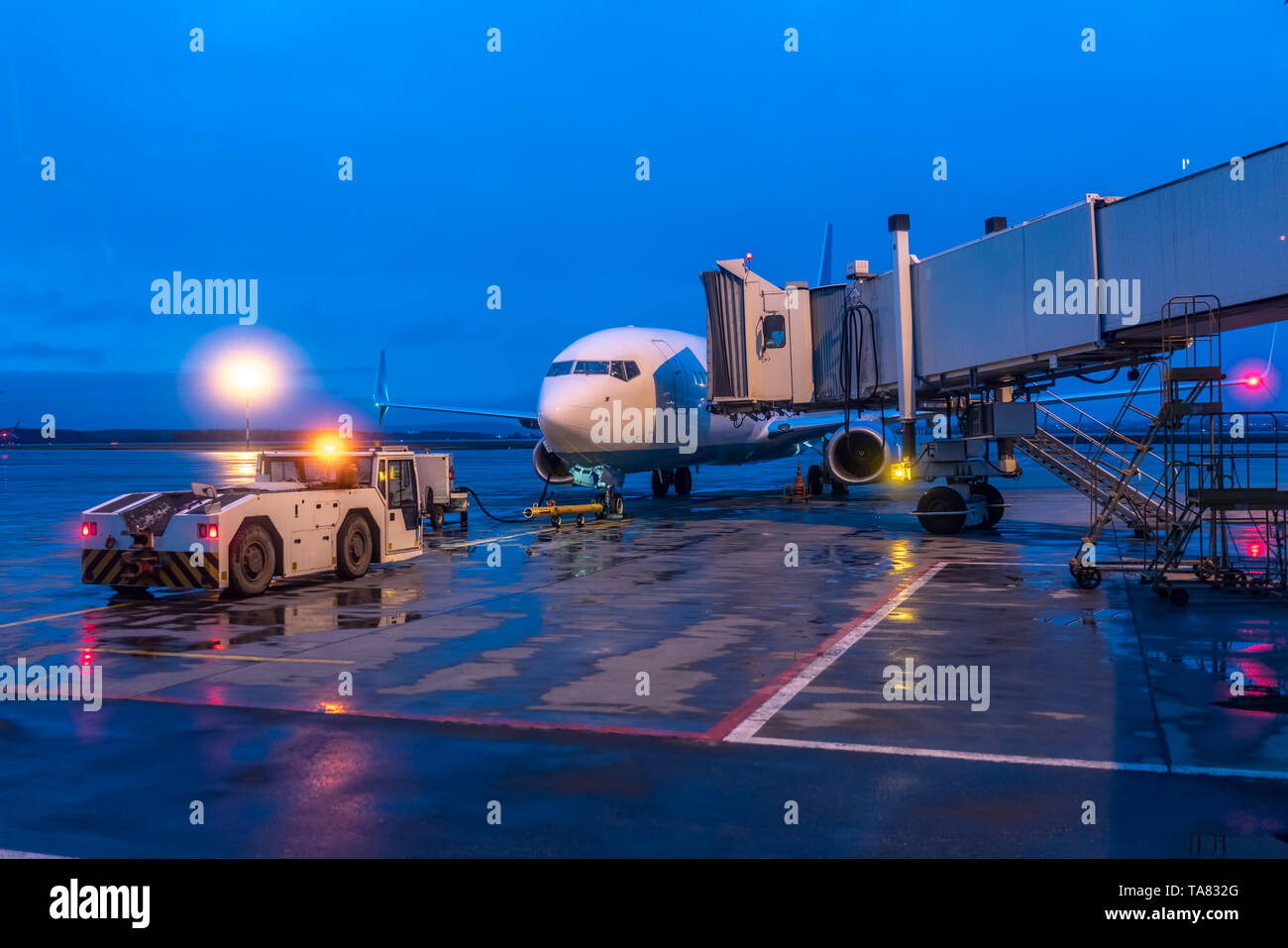 Passenger plane on the airfield connected to walkway.The gate sleeve is ...