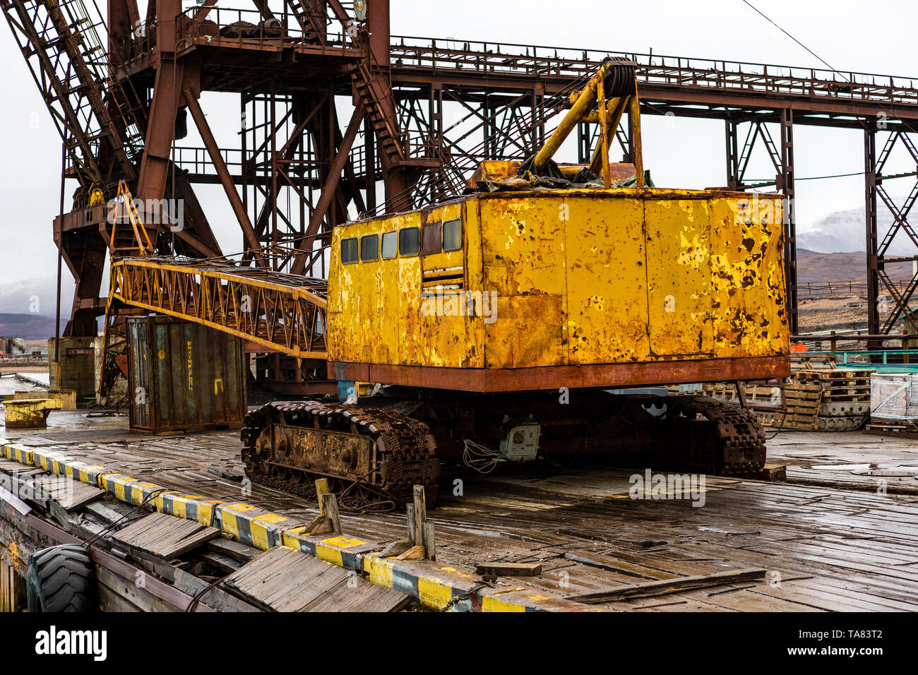 The sudden abandoned russian mining town Pyramiden. rusted harbor with ...