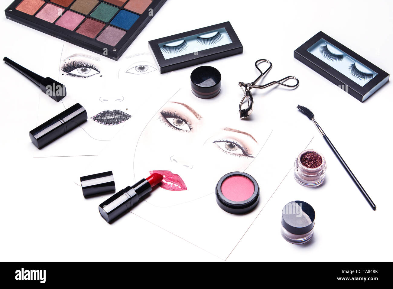 Face charts and different makeup objects and cosmetics on white ...