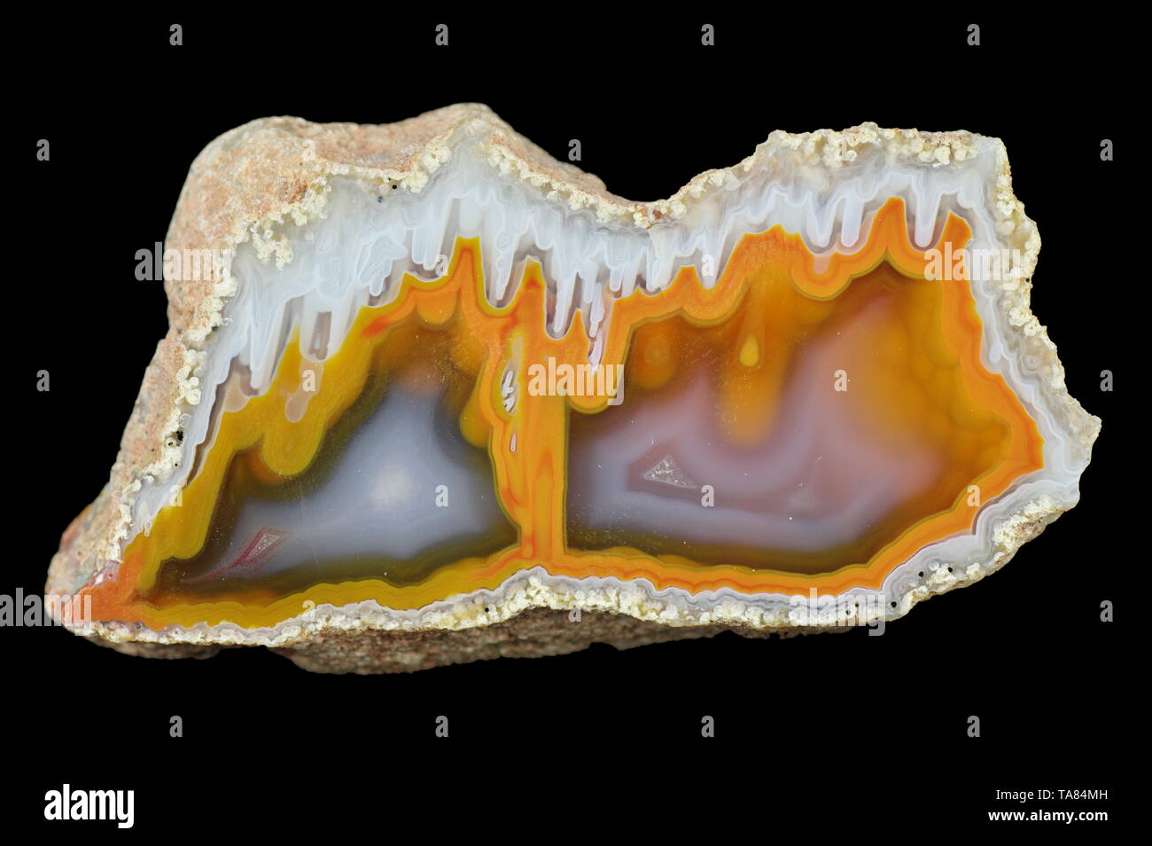 A cross section of the stalactite agate. Multicolored silica bands ...