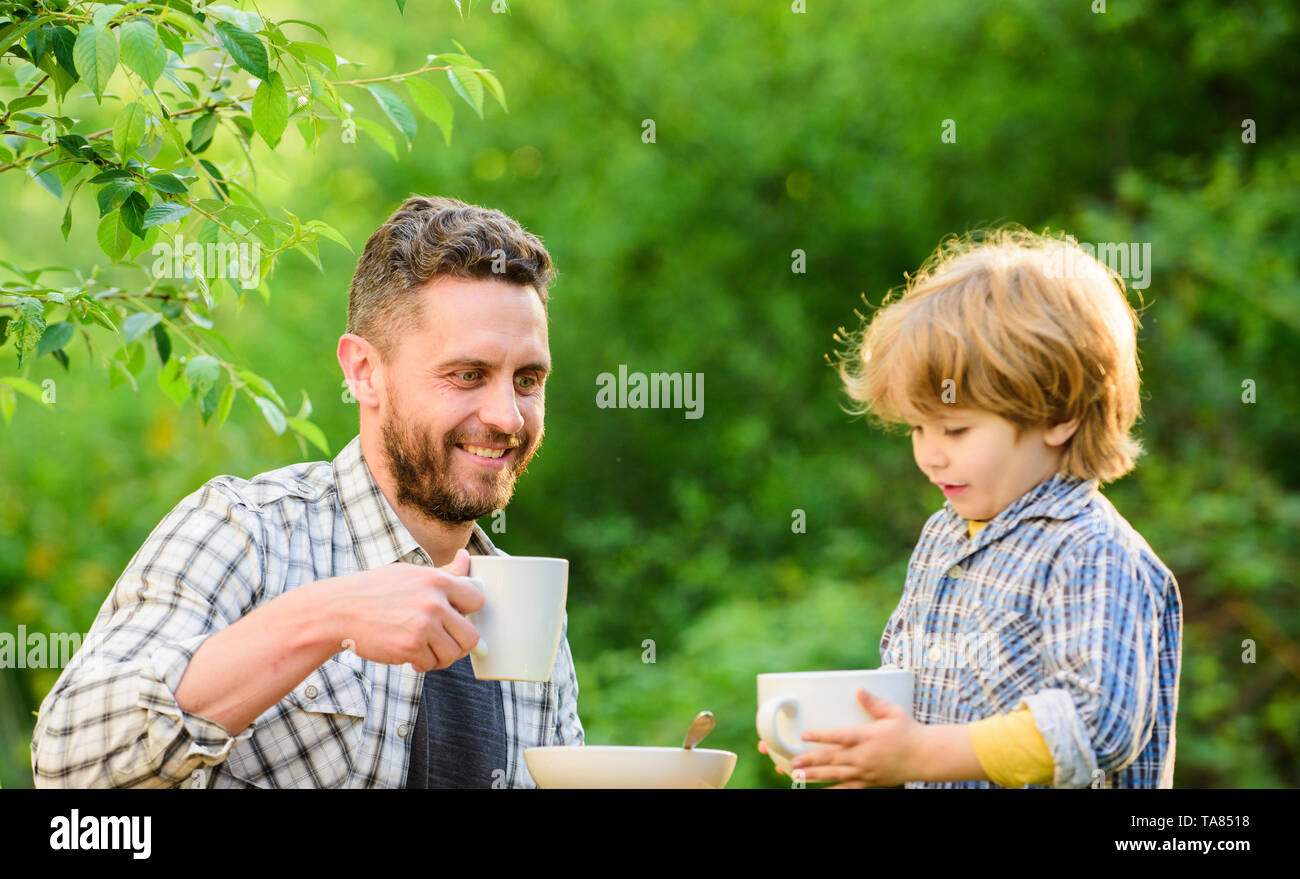 Feeding son natural foods. Healthy food. Father and boy drink tea ...
