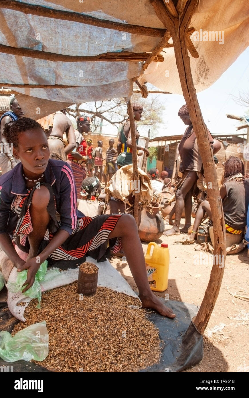 Girl selling grain at the weekly market Stock Photo - Alamy