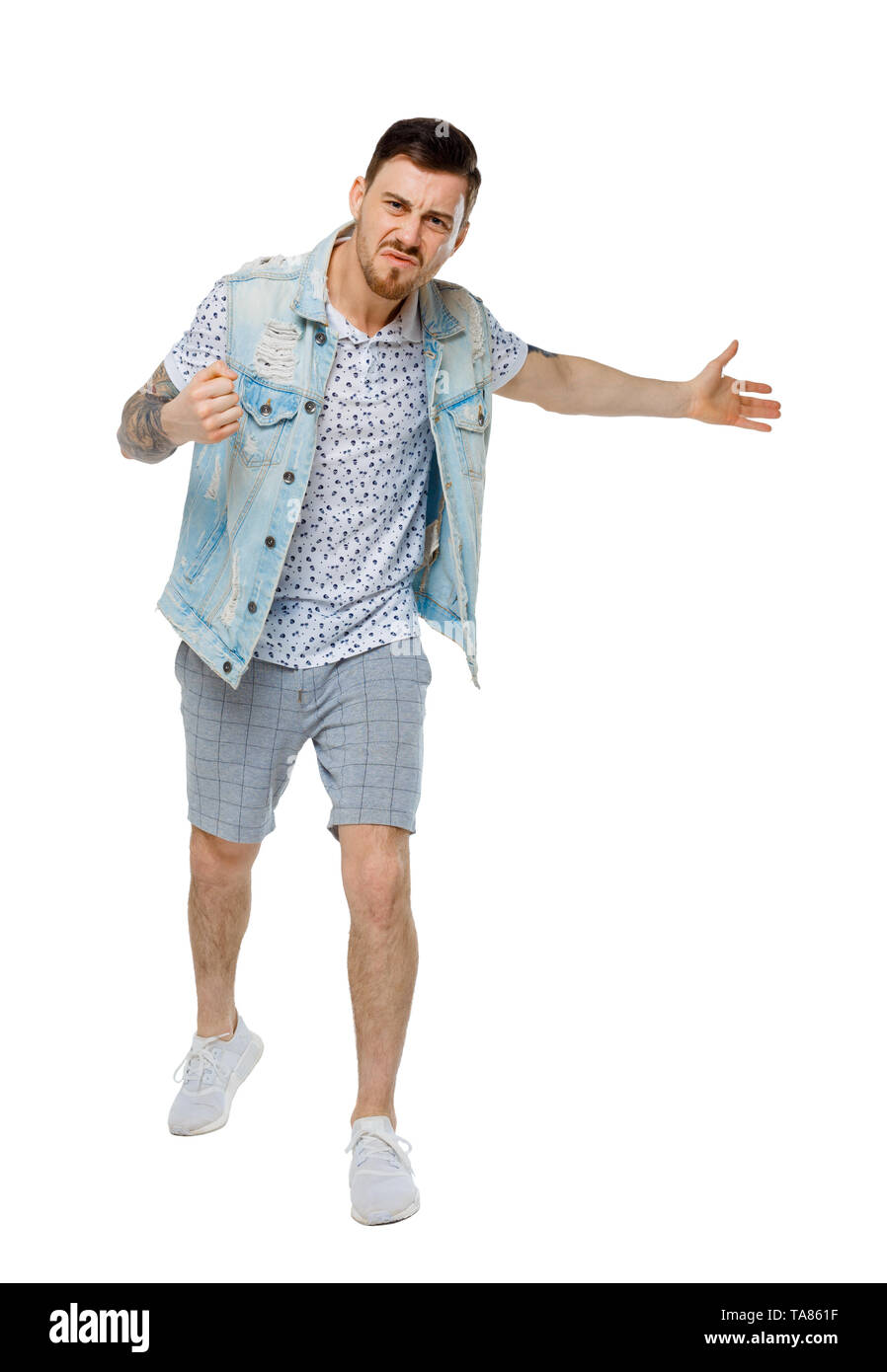 The man screams. Aggressive guy in tattoos yelling at the frame and ...