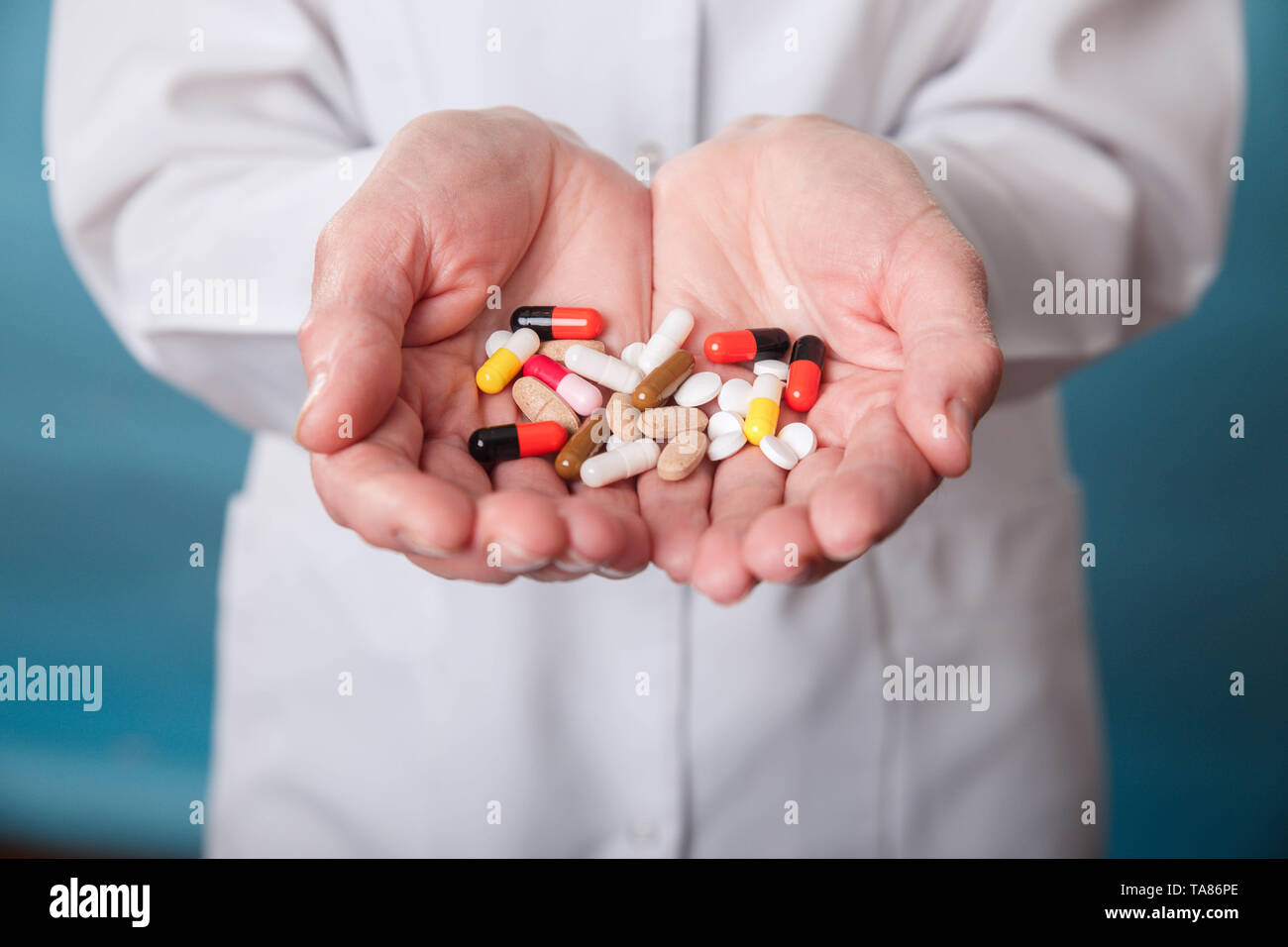 Female holds pills of different color in hand. Concept of health Stock ...