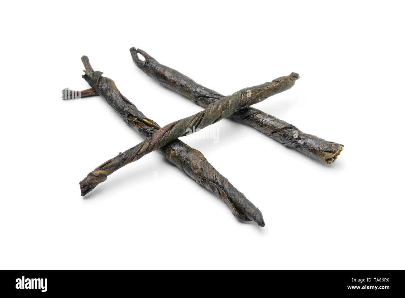 Chinese Kuding tea needles isolated on white background Stock Photo - Alamy