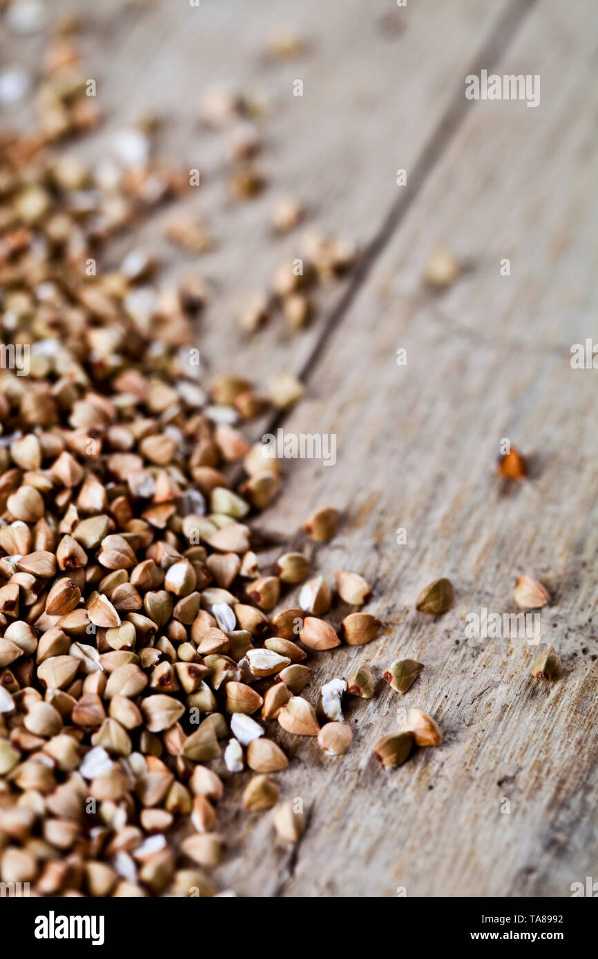 Fresh green dry buckwheat seads closeup on rustic wooden background ...