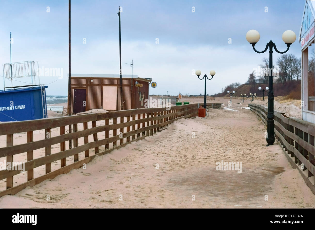 sand-covered promenade, sea promenade after storm, Yantarny village ...