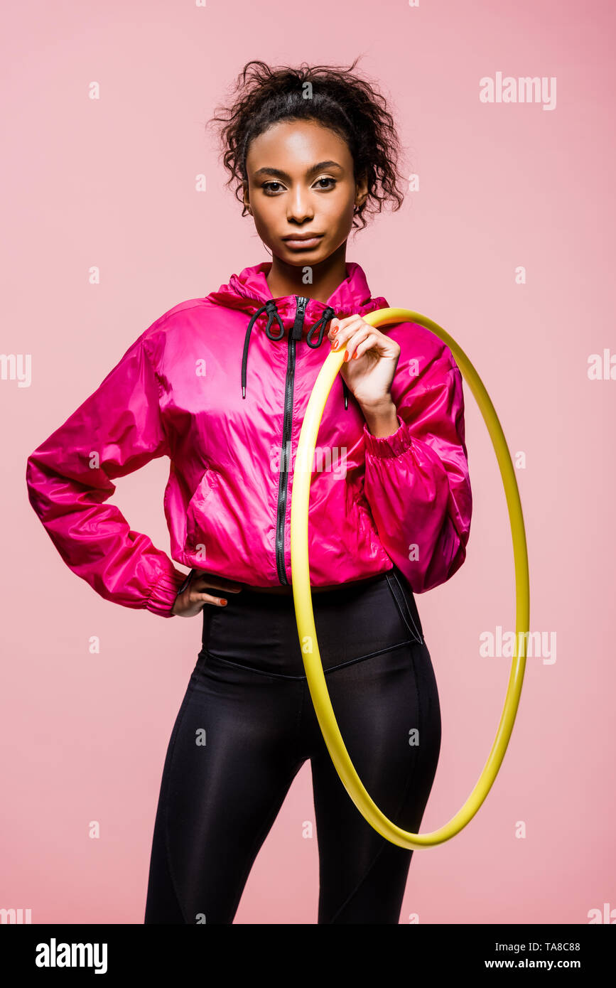 beautiful african american sportswoman looking at camera and holding ...